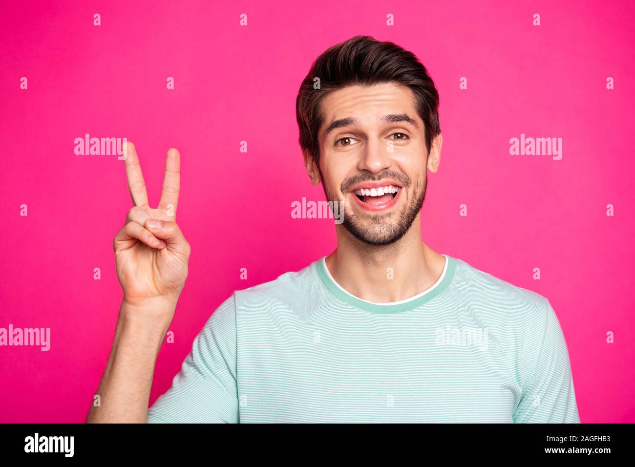Photo of funny macho guy showing v-sign symbol saying hello to best ...