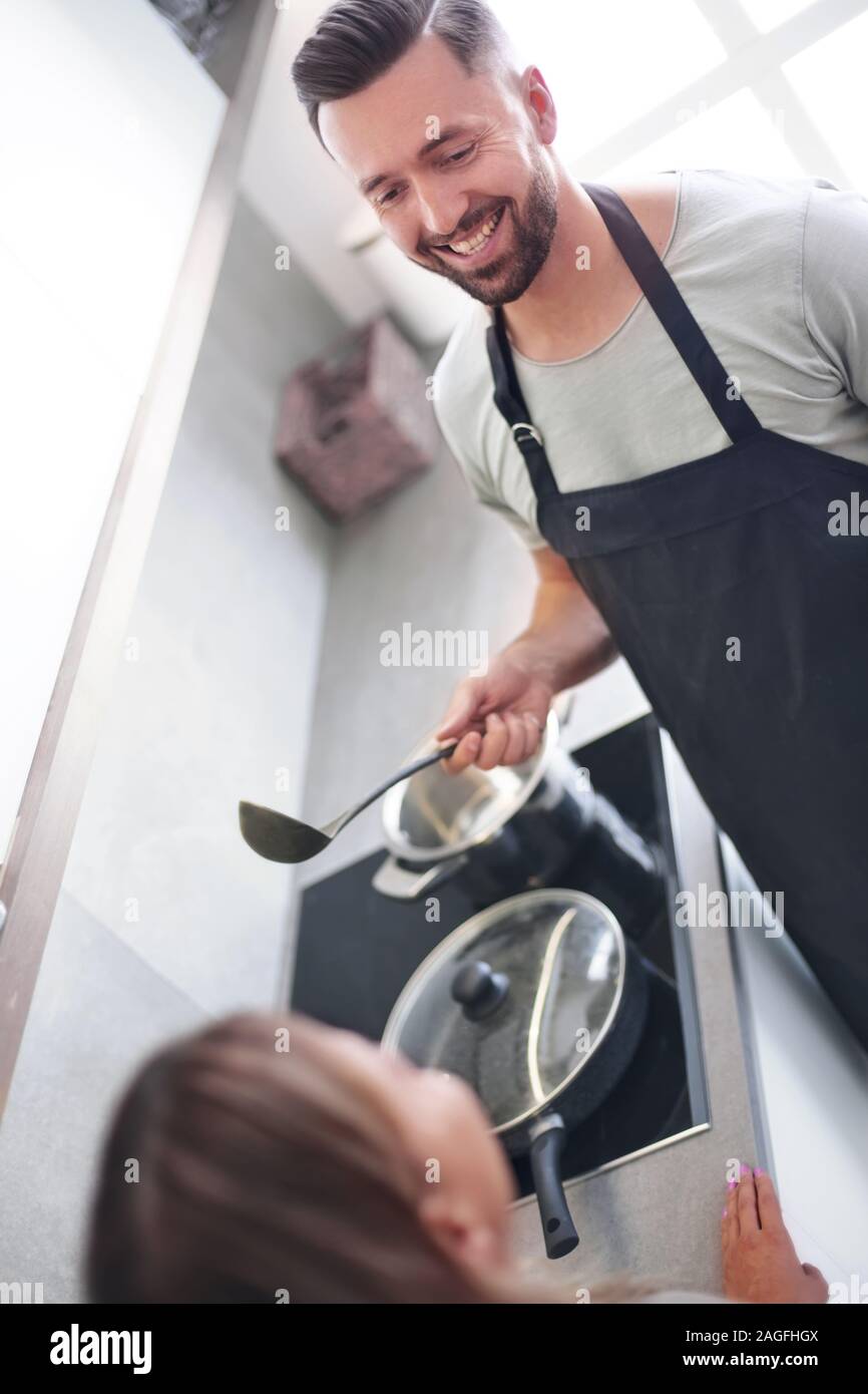 happy couple discussing the menu standing in the kitchen Stock Photo ...
