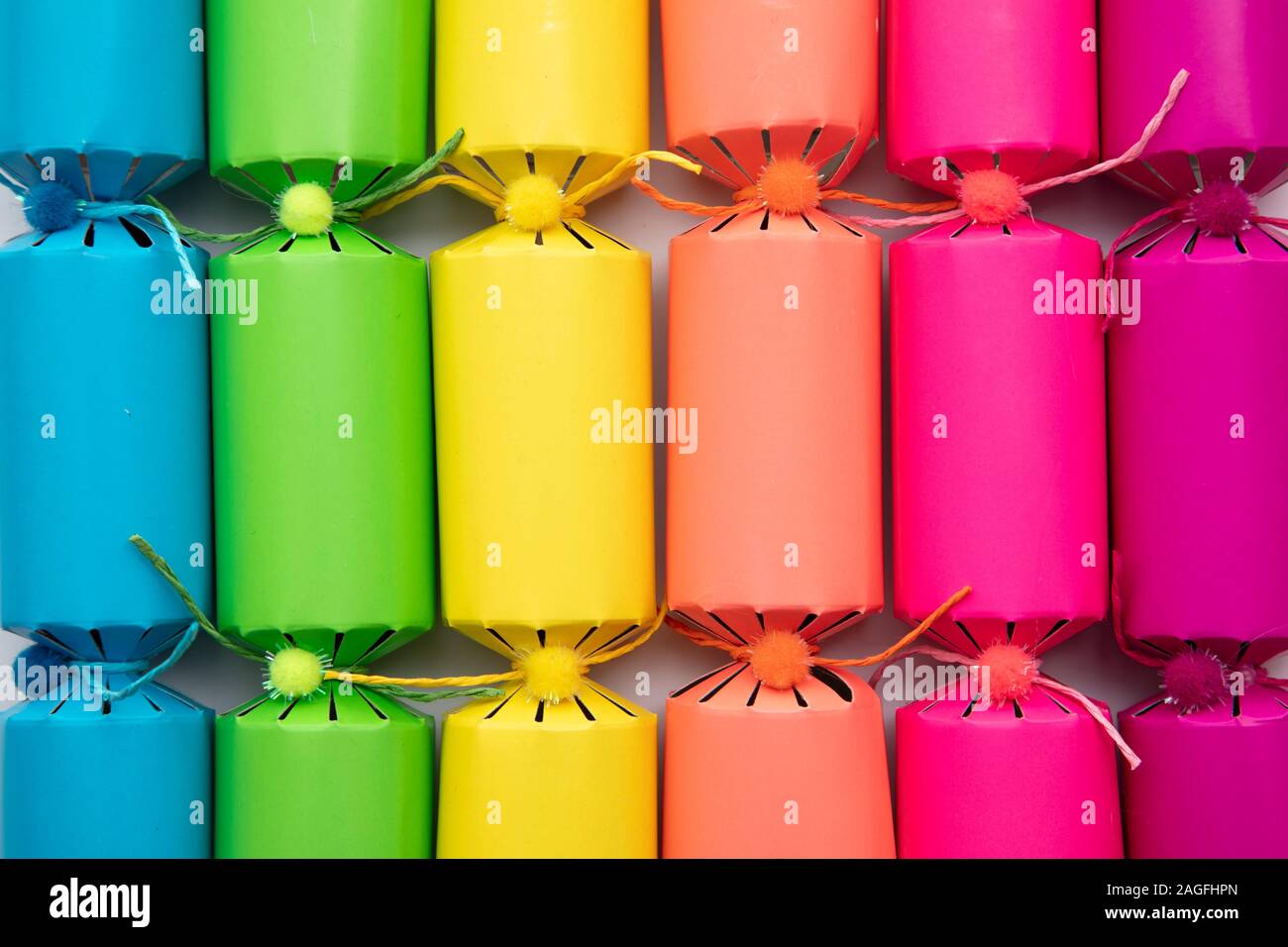Bright colourful hristmas crackers on a plain background. festive ...