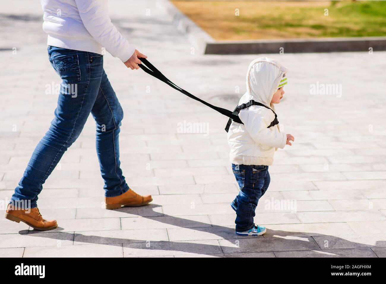 Mothers teach to walk on the road Stock Photo - Alamy