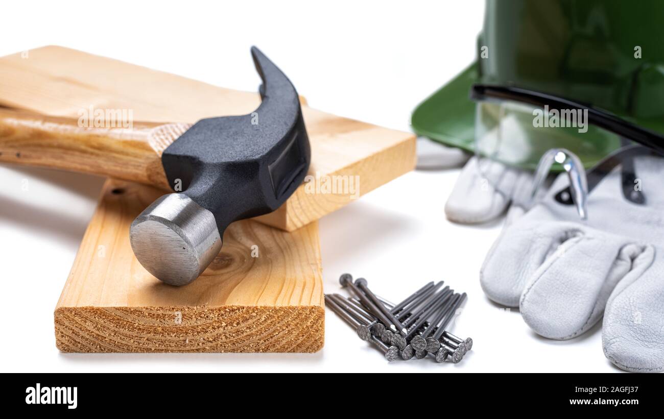 Close-up of a carpenter's hammer, helmet and leather protective gloves ...