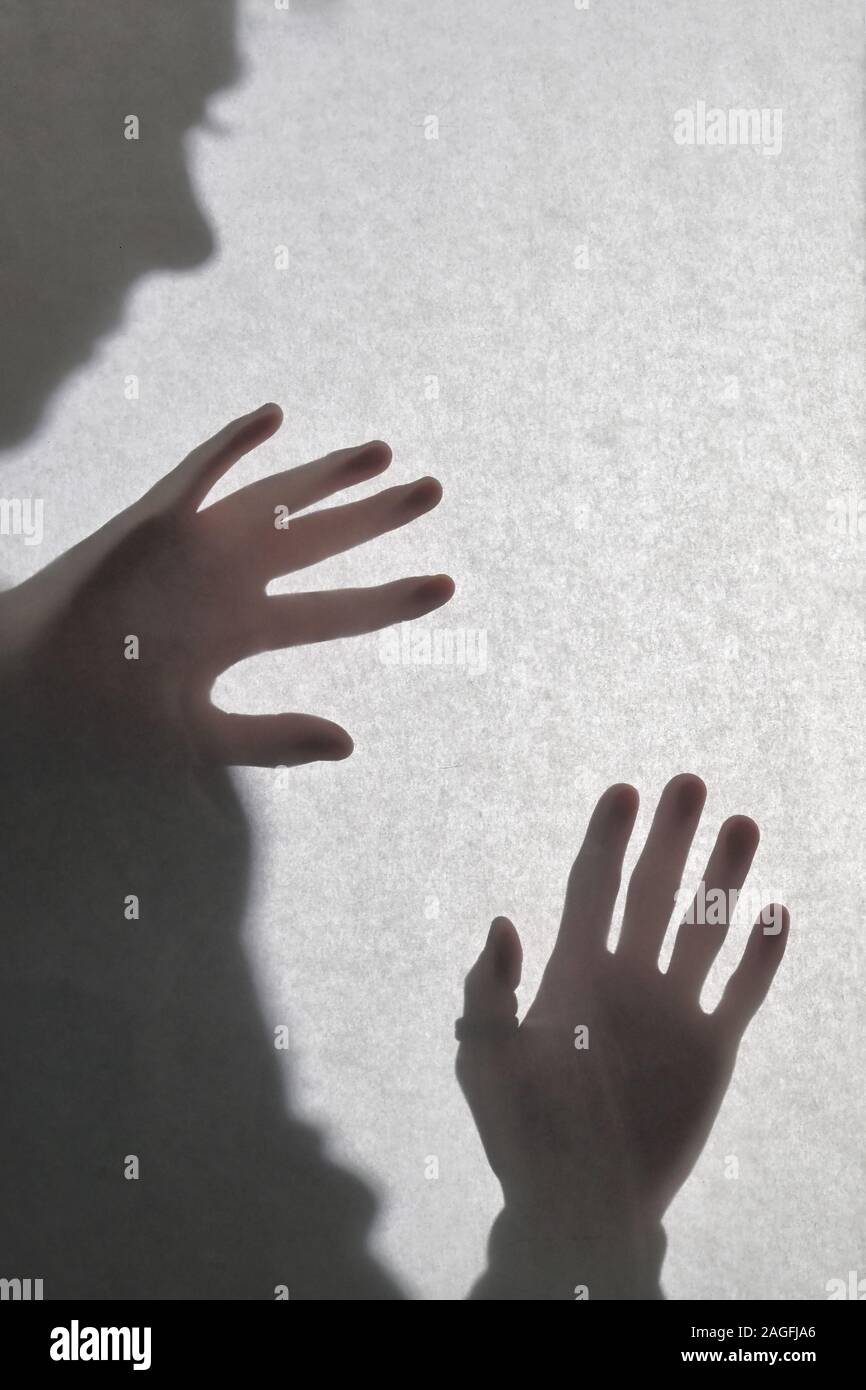 Shadowy Human Figure Behind A Matte Glass Stock Photo - Alamy