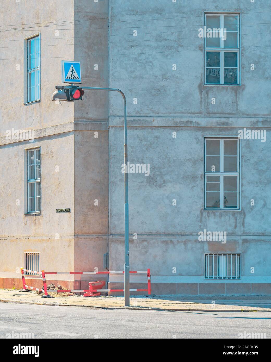 Vertical shot of the traffic light and the street sign in front of a ...