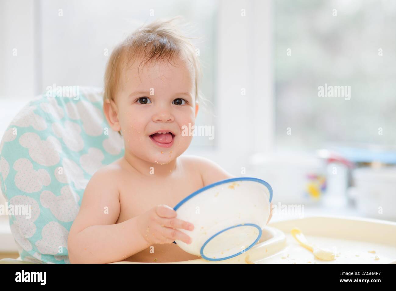 Kid plays in the kitchen with dishes Stock Photo - Alamy
