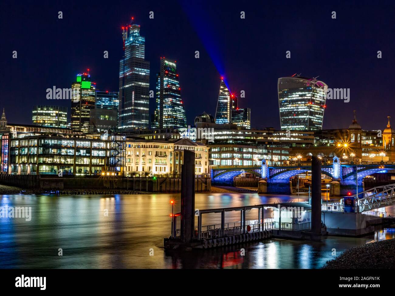 Picture of London with modern buildings and a bridge during the night ...