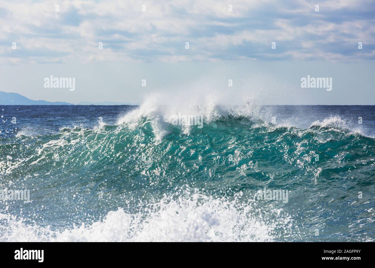 Man standing against the sea on a pier with big wave beating with ...