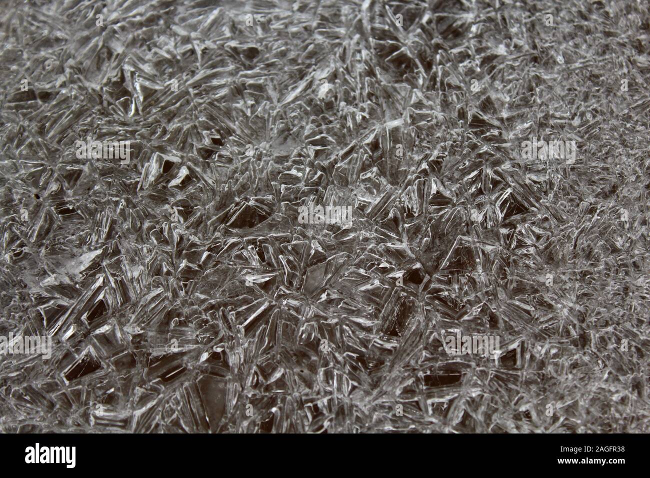 The picture shows frozen ice on a puddle Stock Photo - Alamy