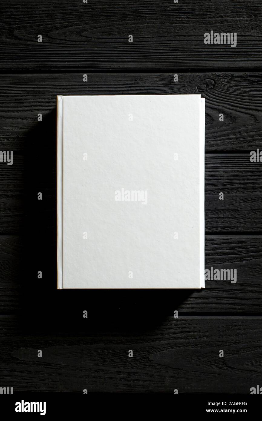 The white-cover book is on a textured wooden table Stock Photo - Alamy