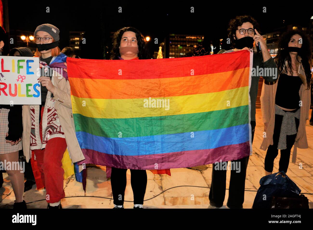 Athens, Greece. 17th Dec, 2019. Protesters hold an LGBT rainbow flag ...