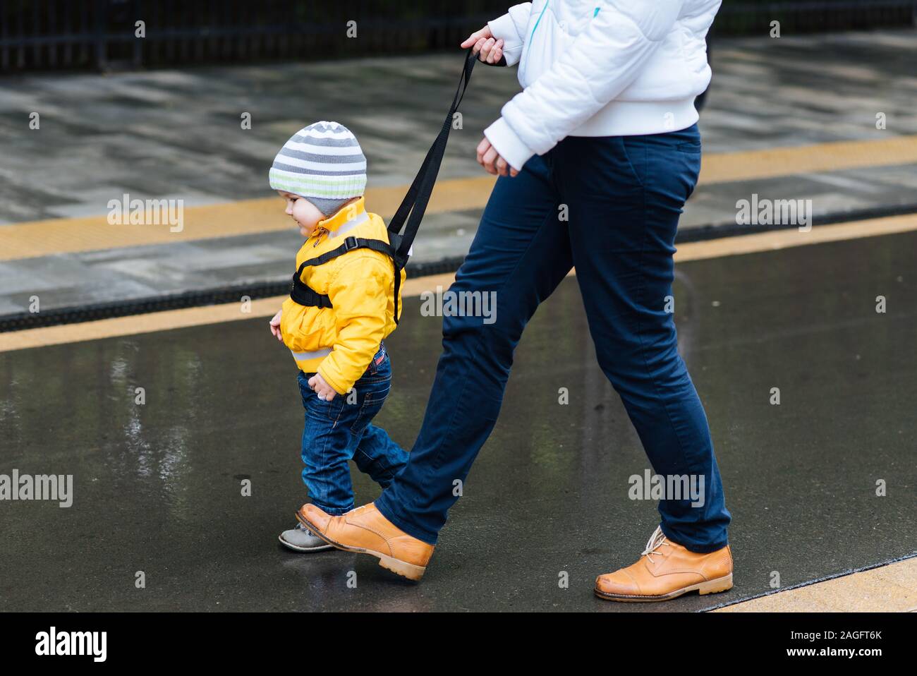 Mothers teach to walk on the road Stock Photo - Alamy