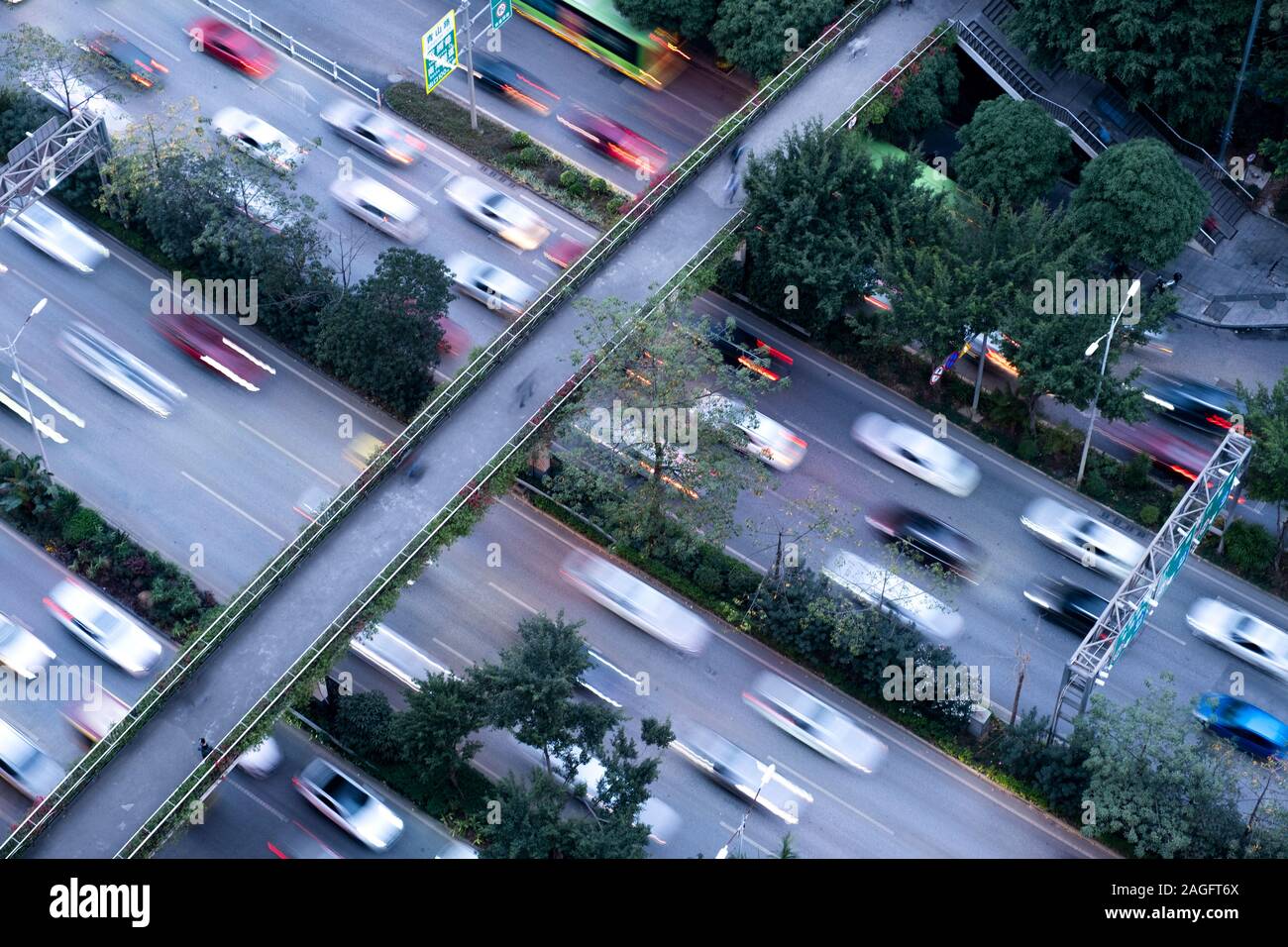 Busy traffic flow and pedestrian overpass in Urban Road peak period ...