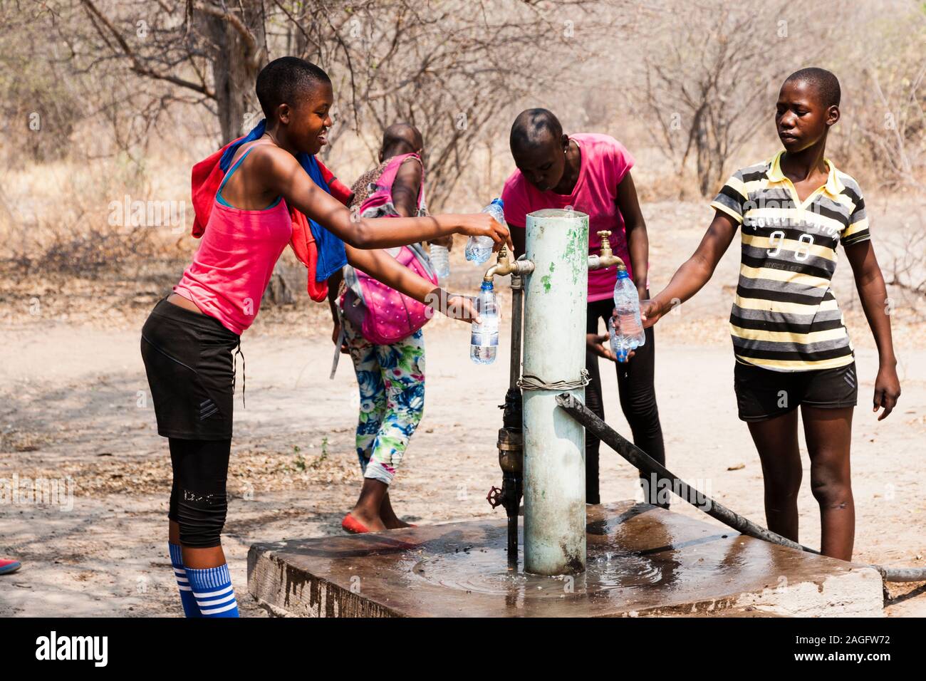 Tsodilo hills rock art sites, local students visiting, taking water ...
