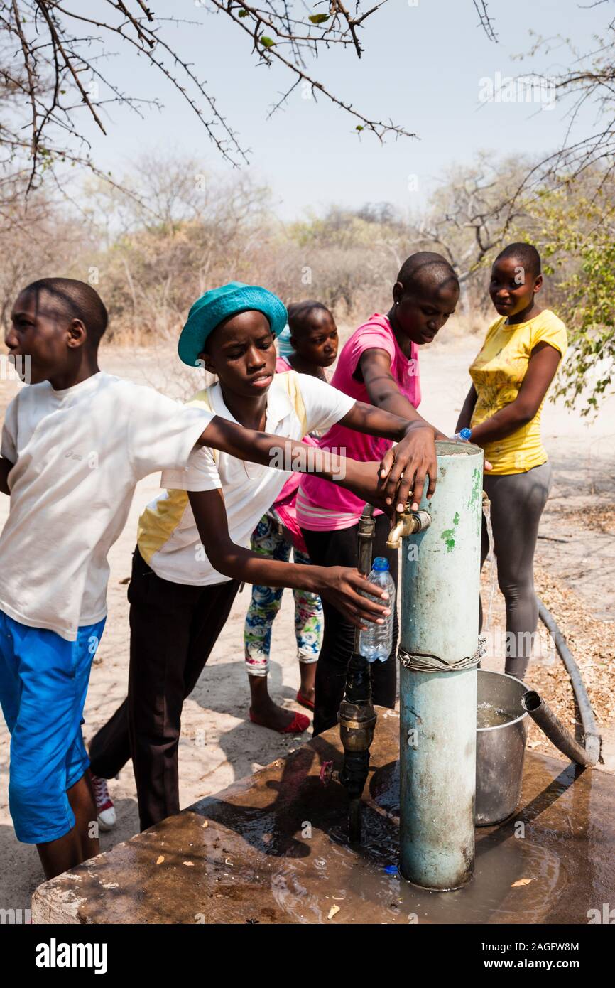 Tsodilo hills rock art sites, local students visiting, taking water ...