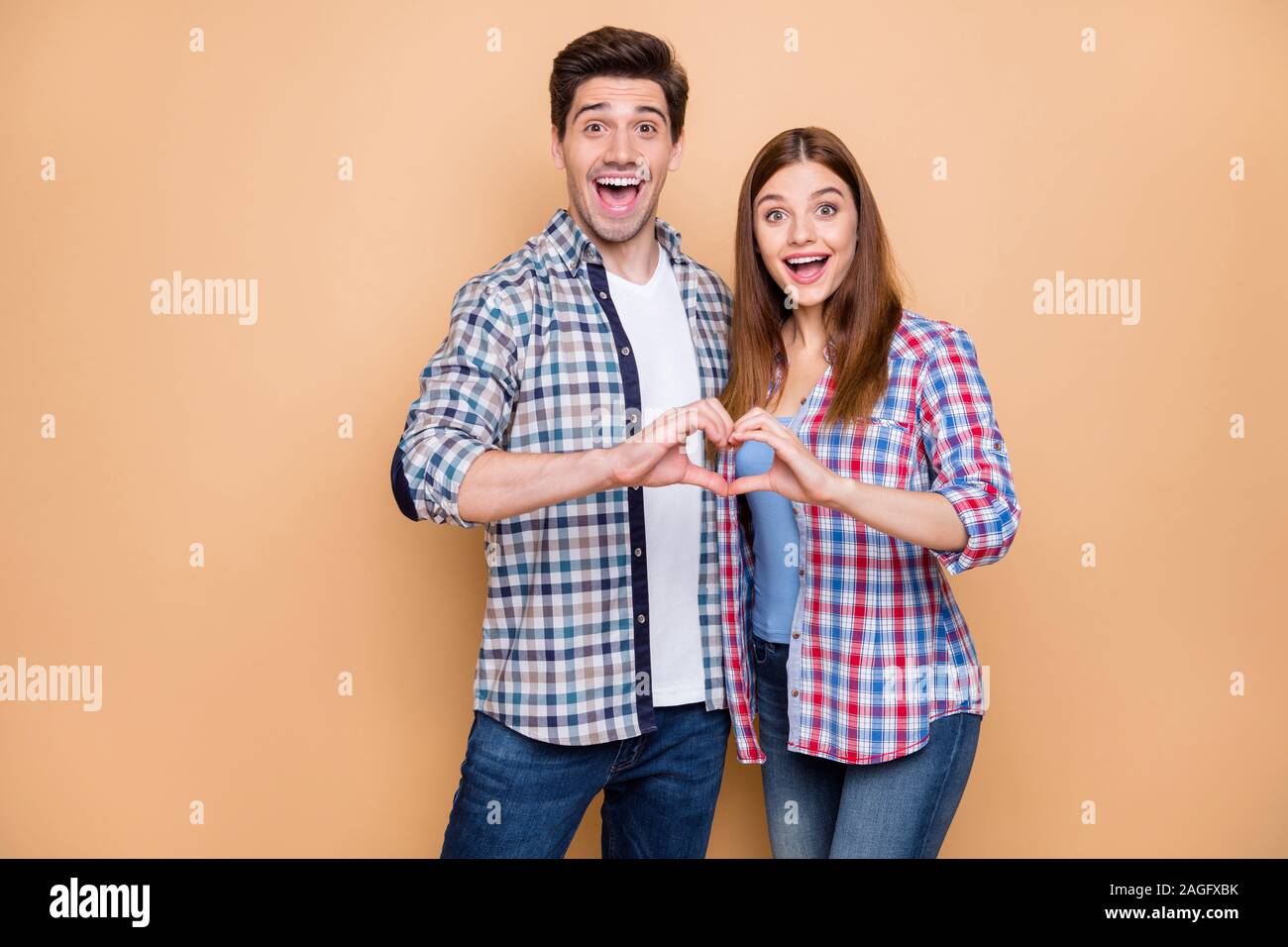 Portrait of excited crazy two people married couple make fingers heart ...
