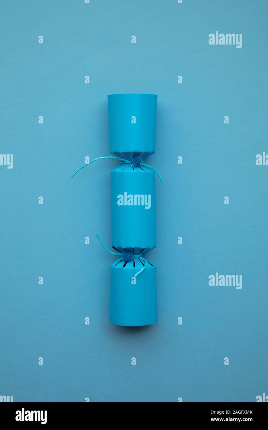 Blue christmas cracker on a blue background Stock Photo - Alamy