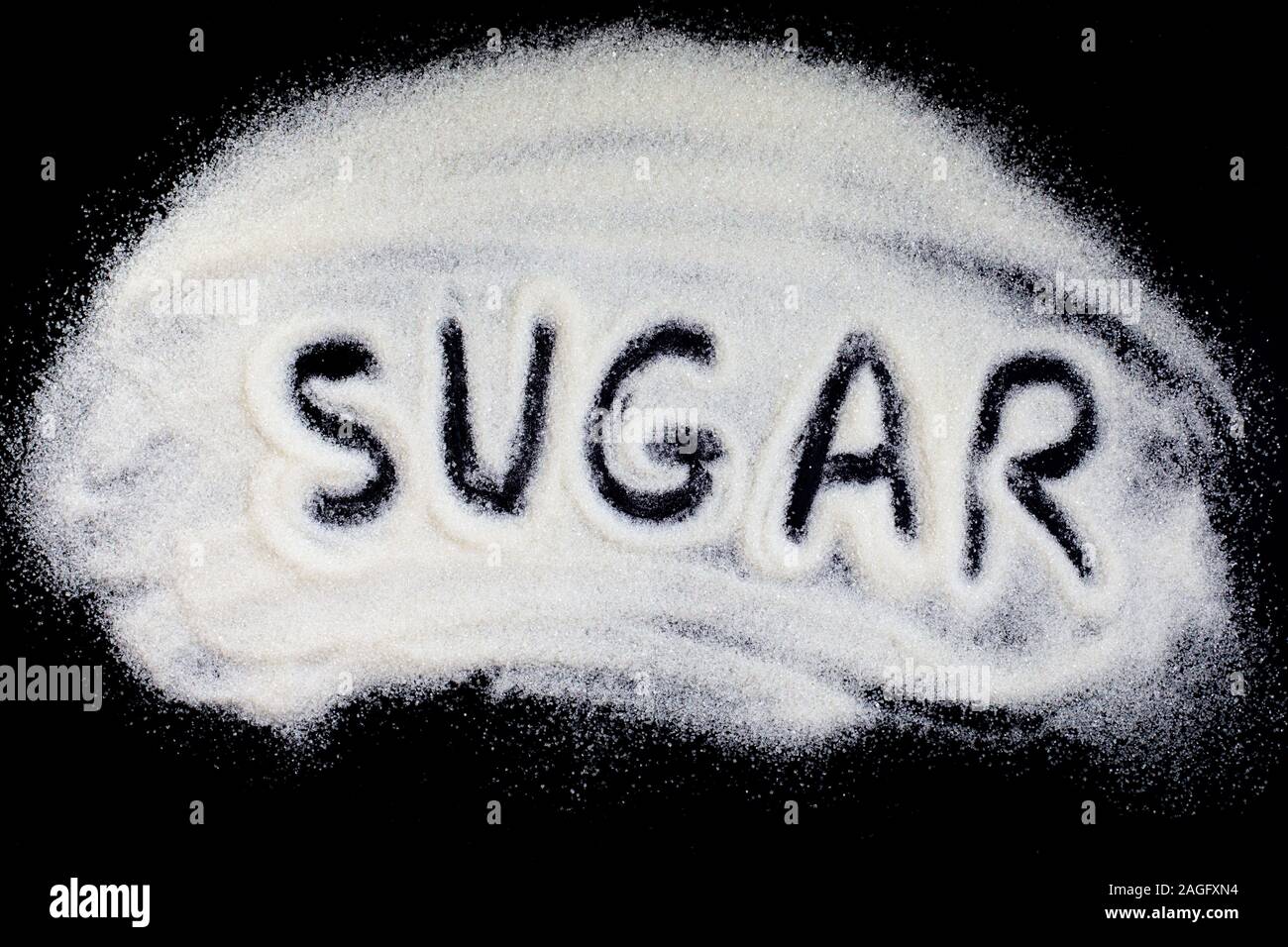 Word sugar hand lettering on a placer of refined white sugar. Beet ...