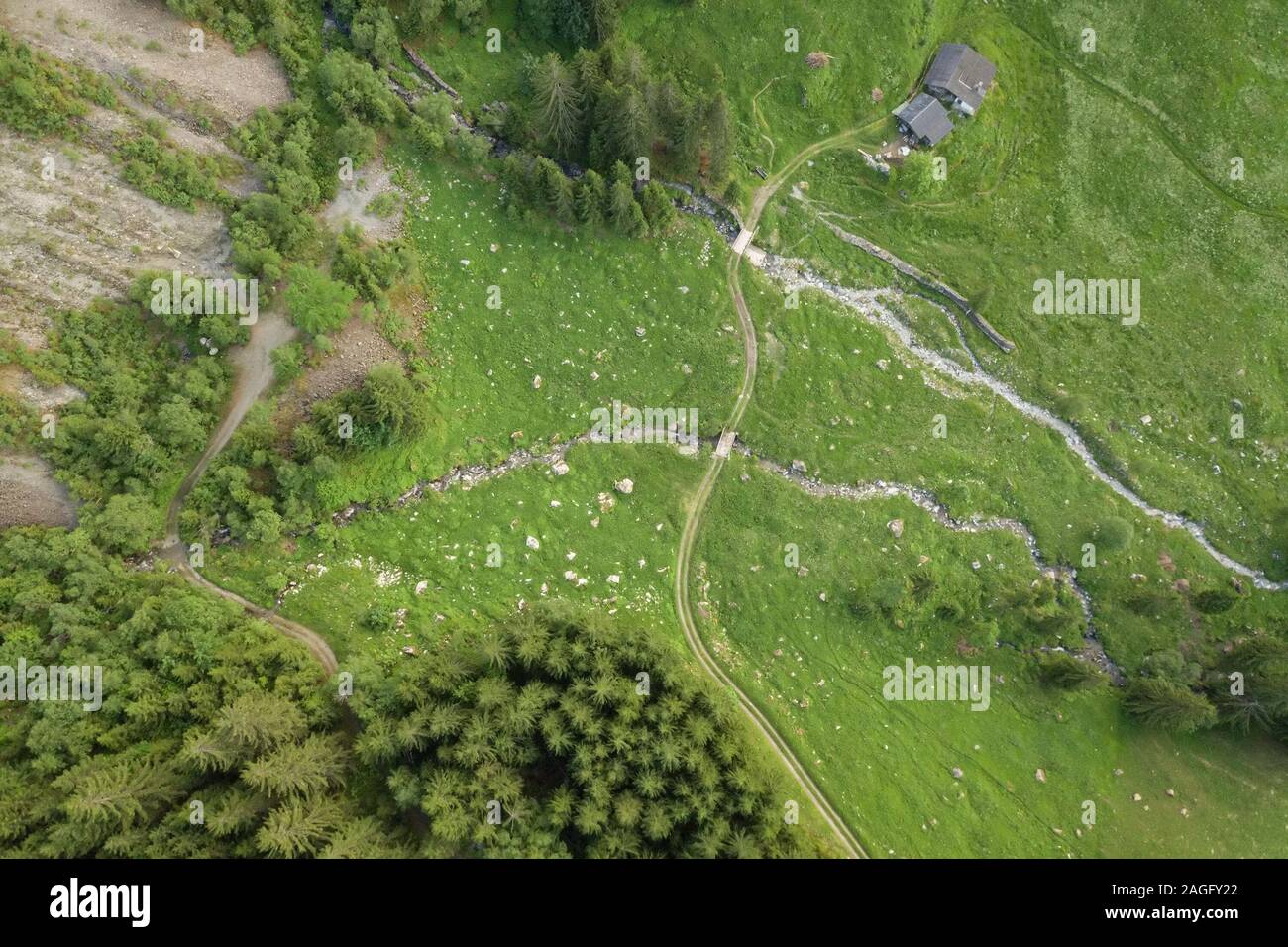 Aerial view of hiking trail over mountain creek in the French Alps ...