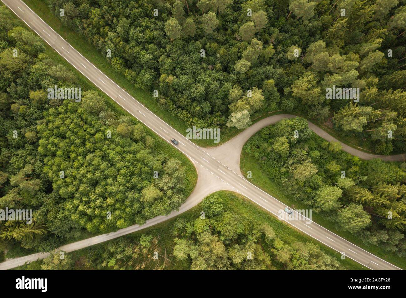 Top view of cars driving on road with intersection through forest Stock ...