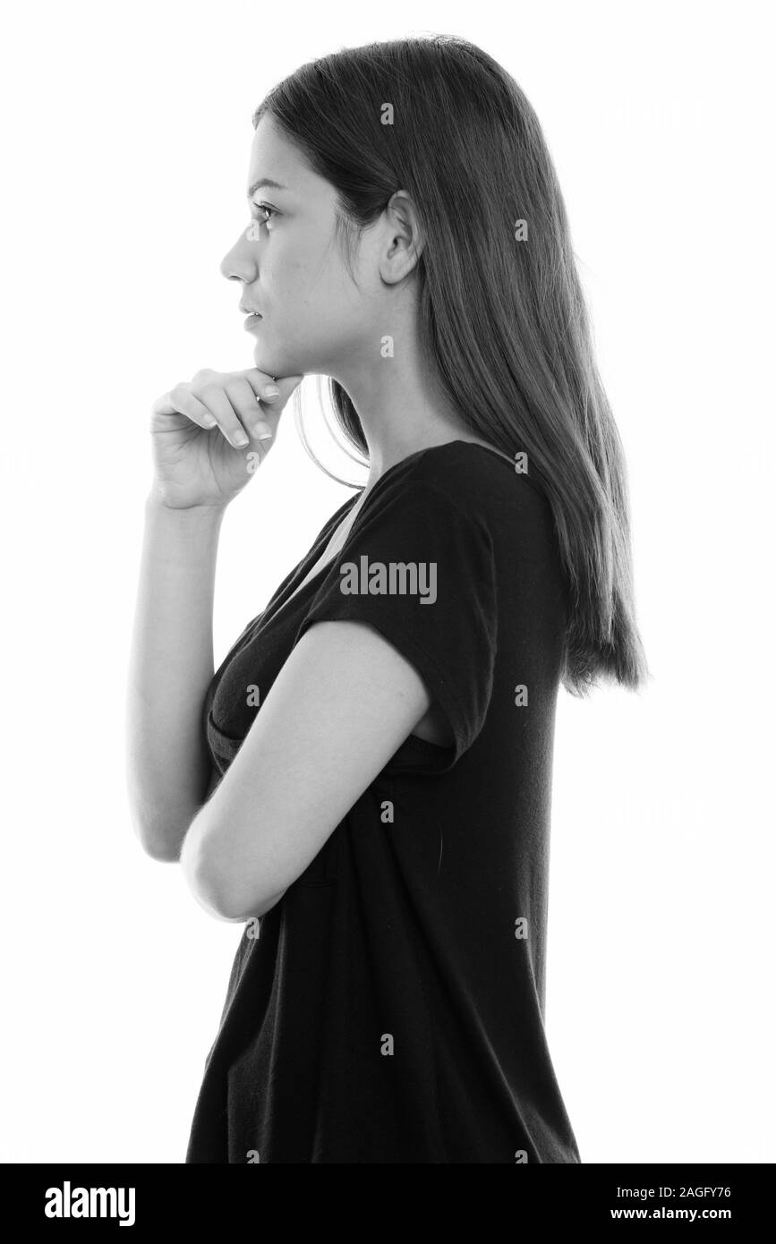 Profile view of young beautiful woman thinking Stock Photo - Alamy