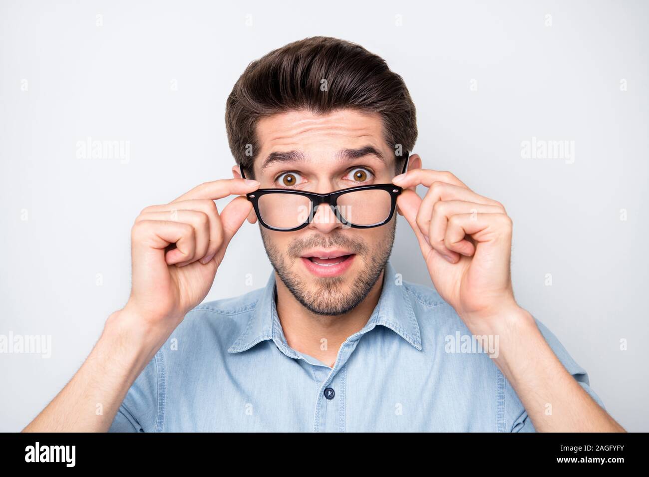 Close up photo of speechless man shocked with his eyesight corrected ...