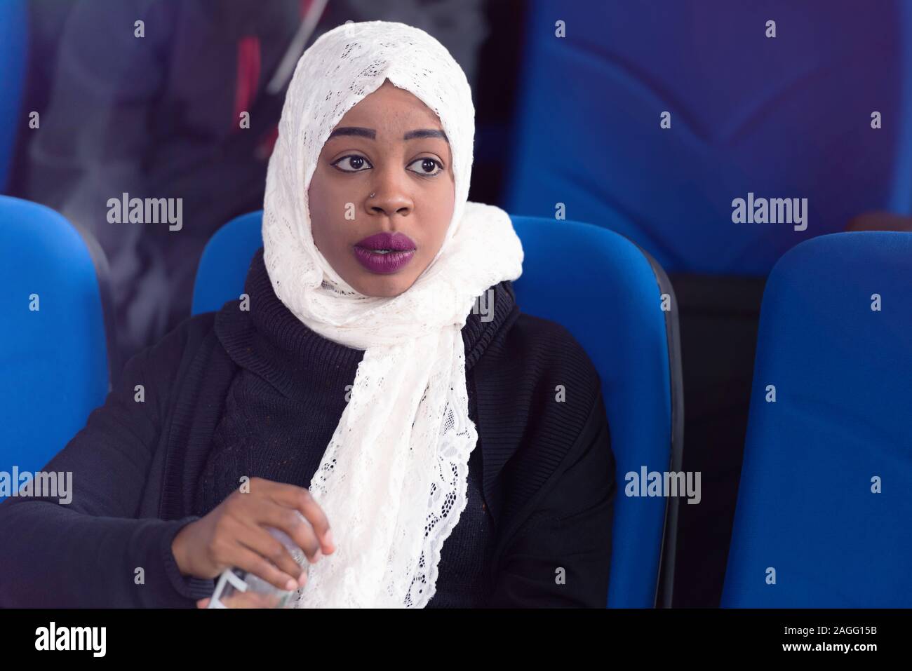 African american muslim business woman listening and watching ...
