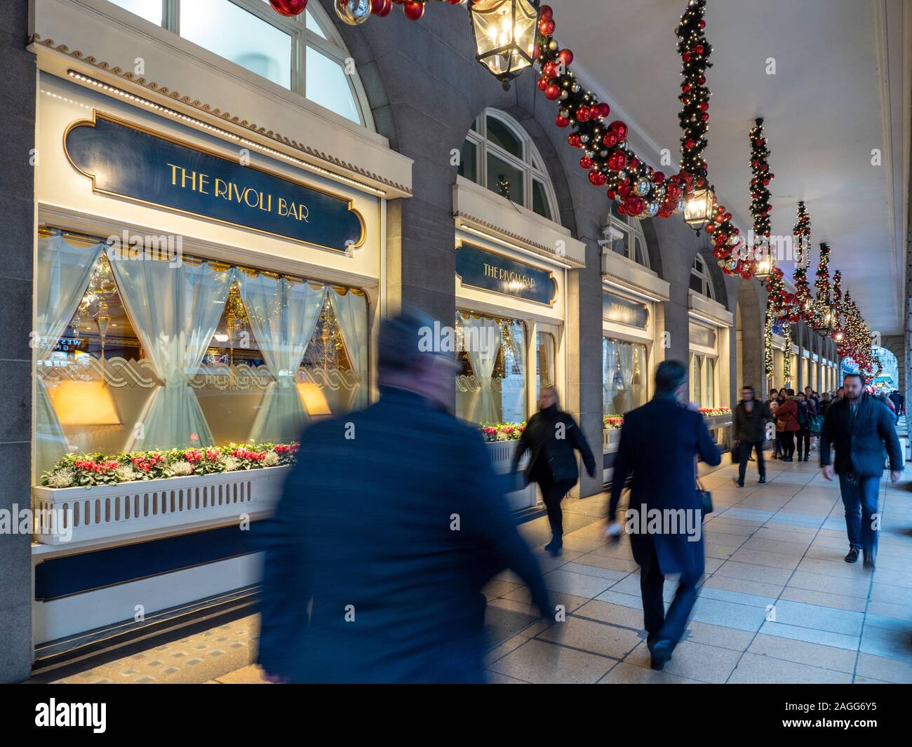 People walk past the Ritz hotel London UK, with slow shutter speed and ...