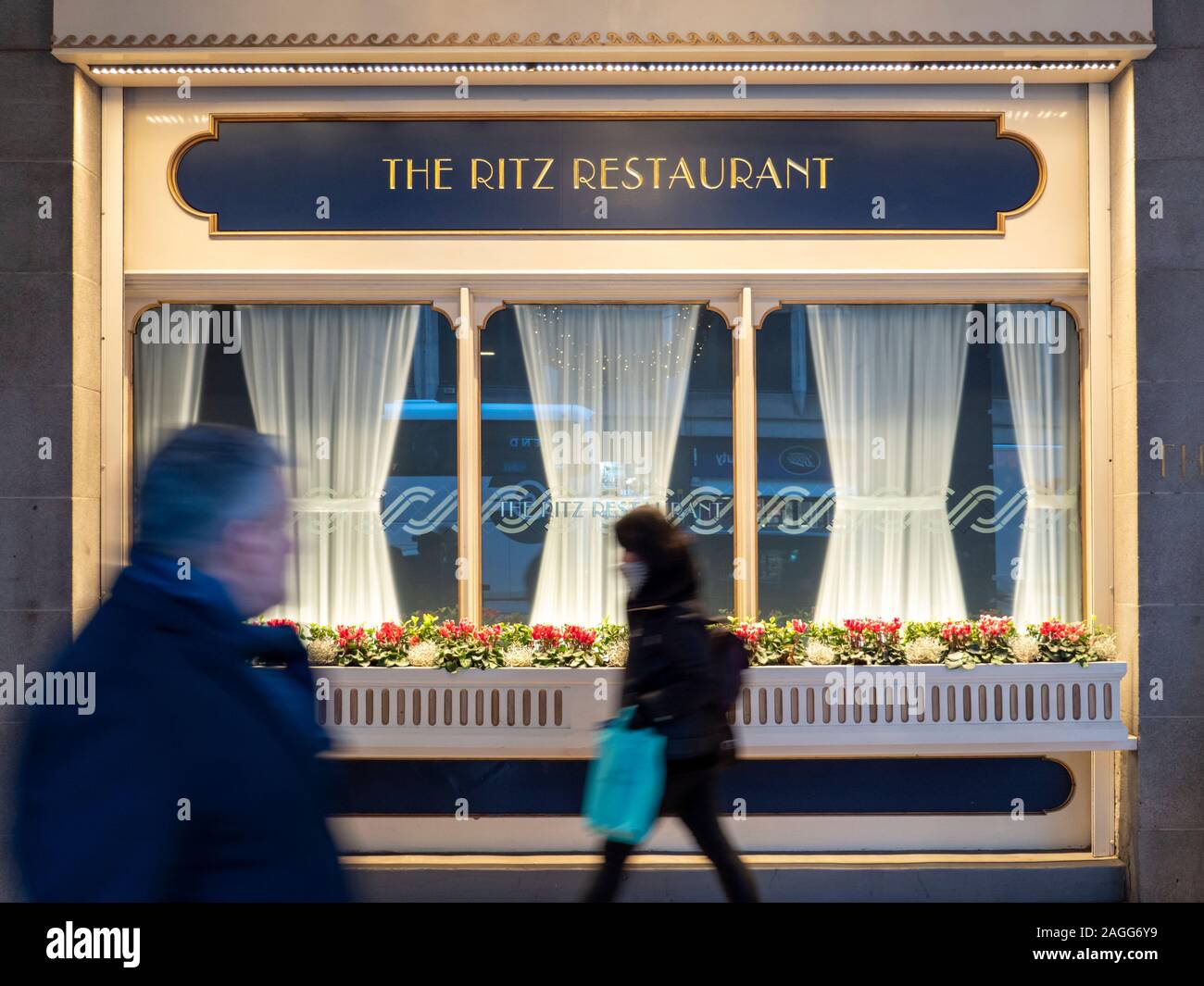 People walking past the window of the Ritz restaurant London UK, with ...