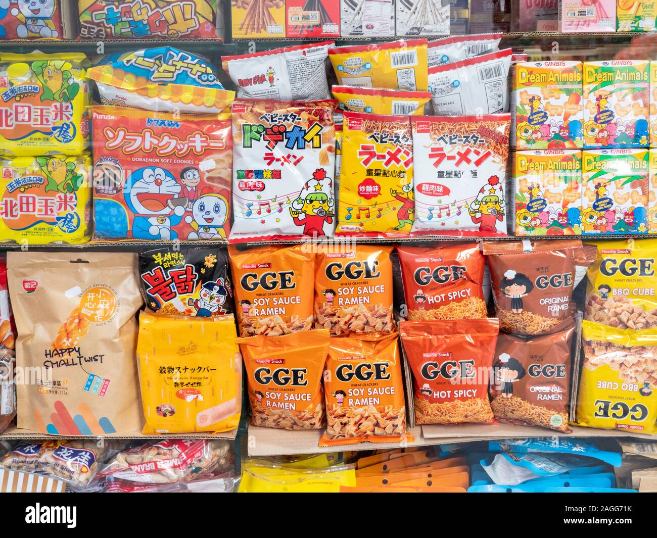 Packaged chinese food ingredients for sale piled up in in a shop window ...
