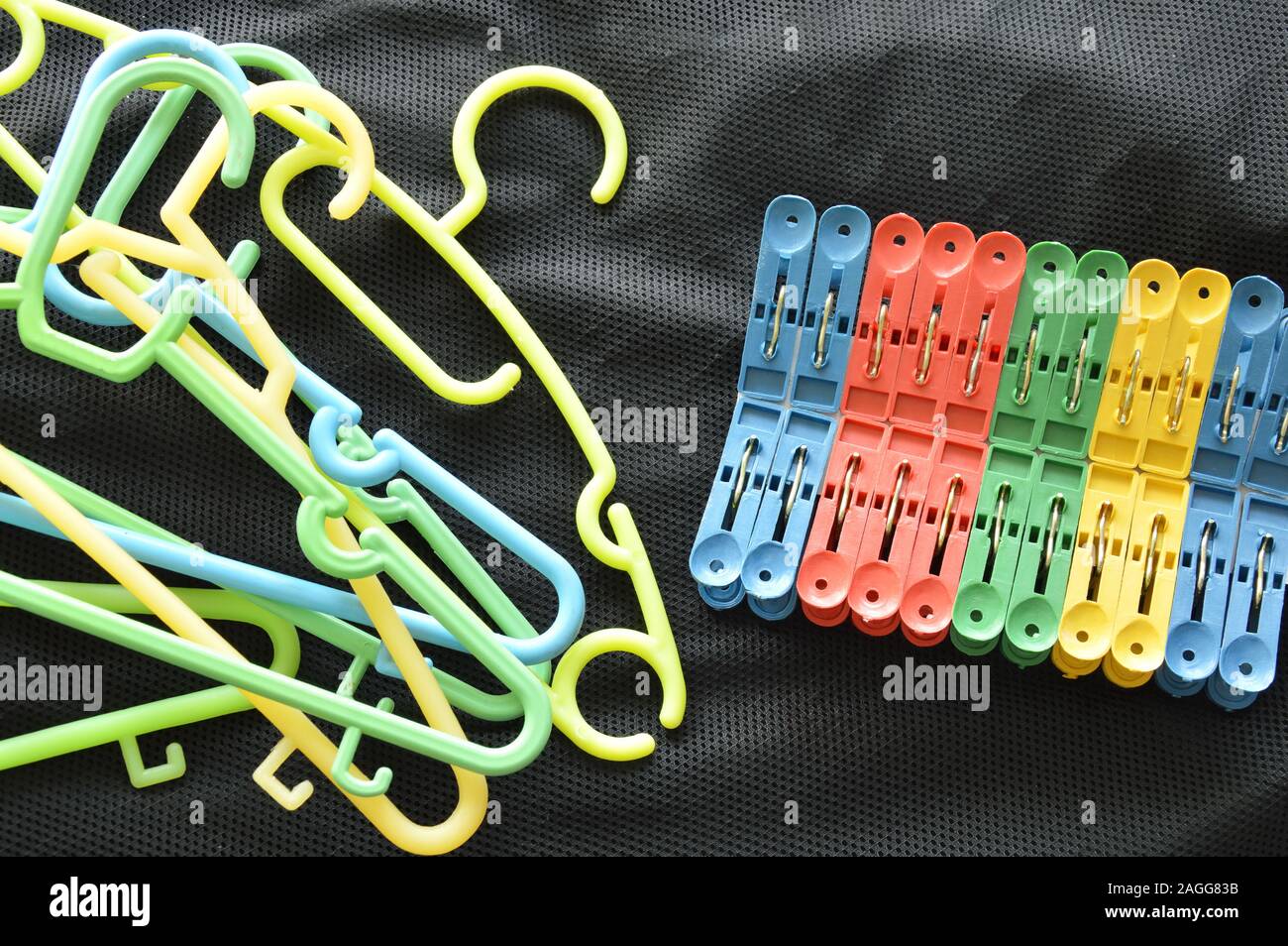 colorful plastic clothes peg and hunger on black fabric Stock Photo - Alamy