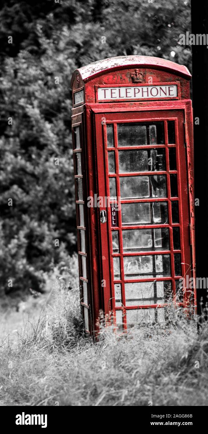 A traditional old red telephone box in the country, British, English ...
