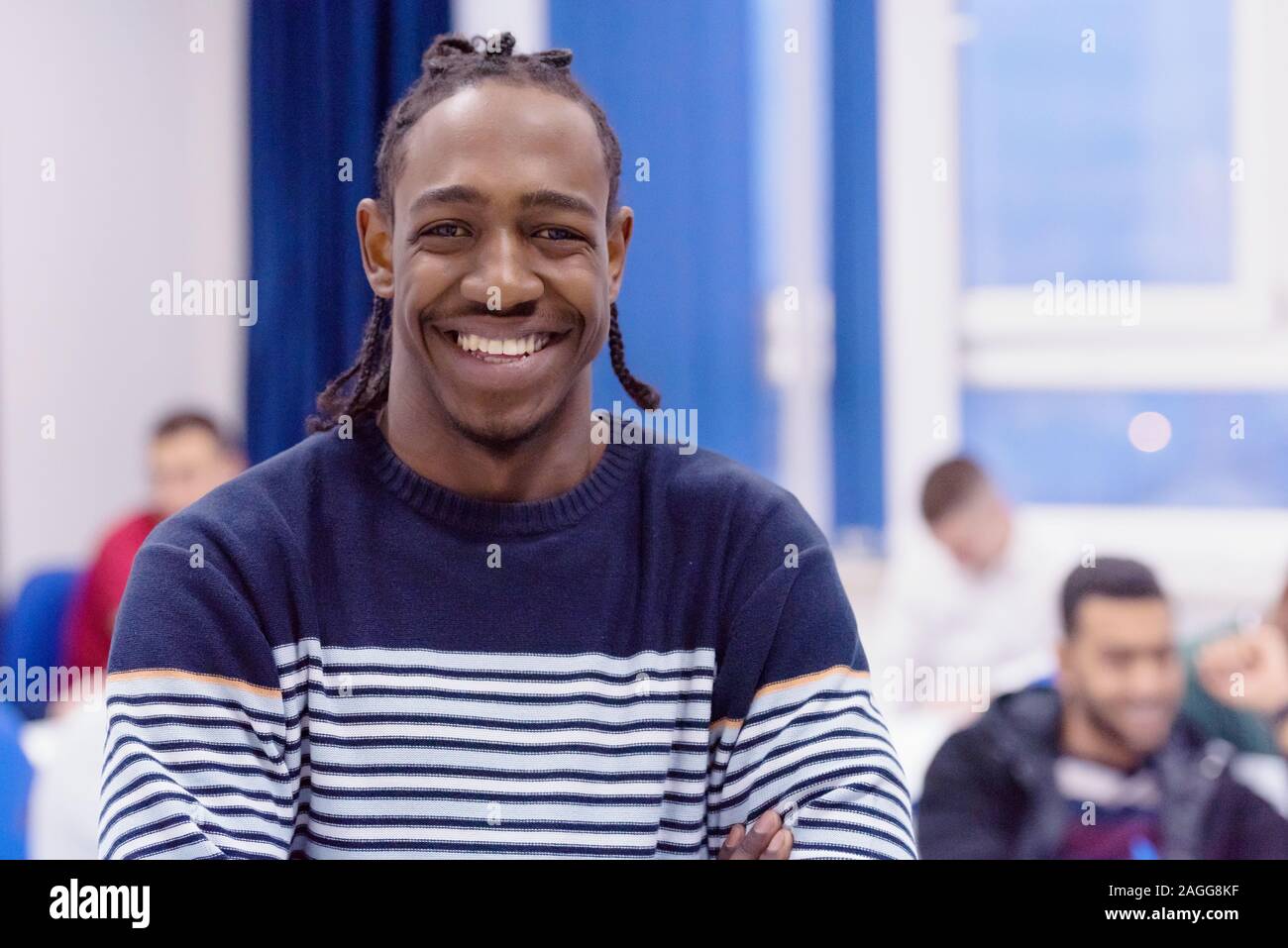 African american university male student in class smiling at the camera ...