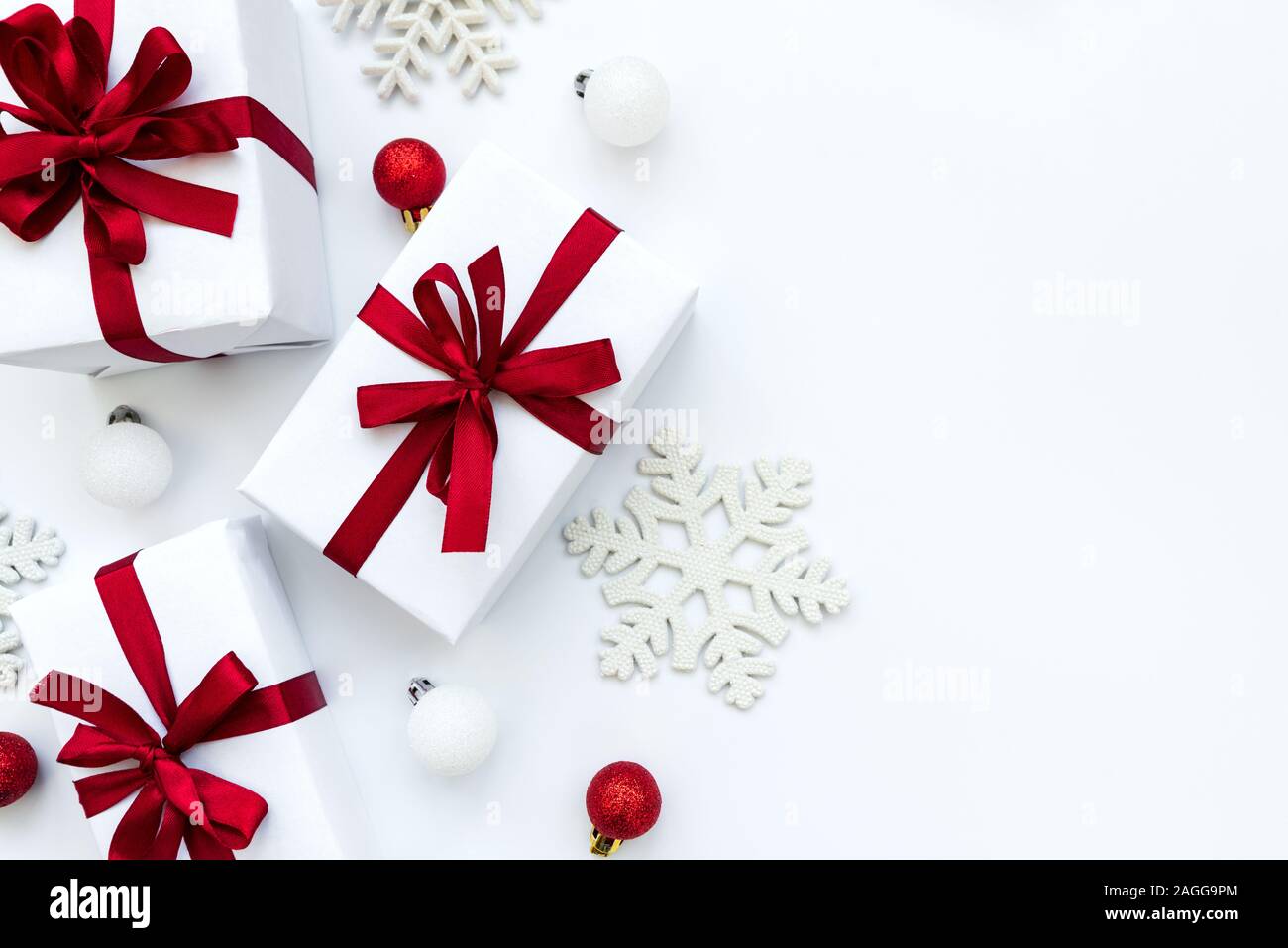Border from gift boxes wrapped white paper and red ribbon decorated ...