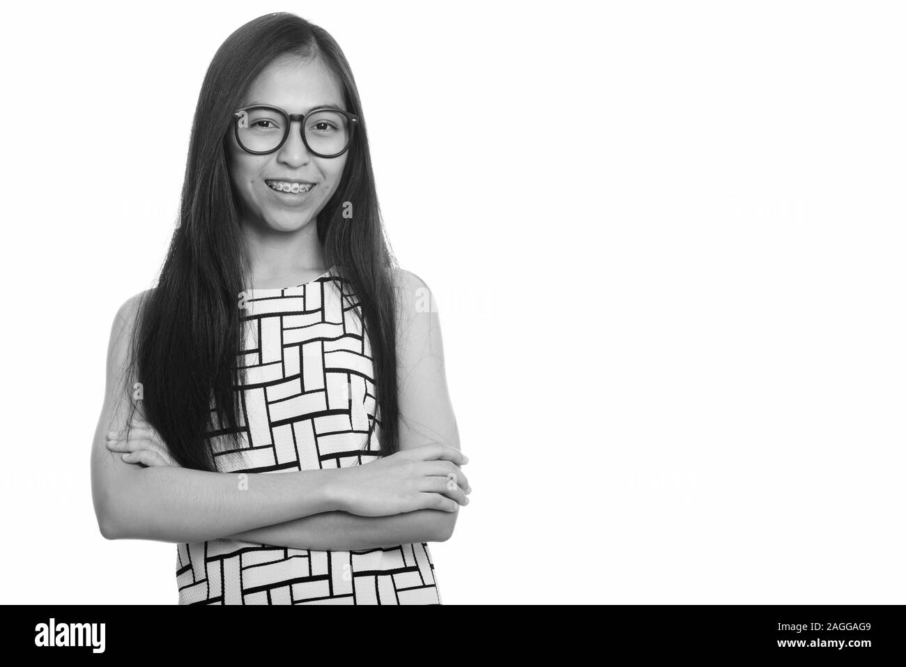 Young happy Asian teenage nerd girl smiling with arms crossed Stock ...