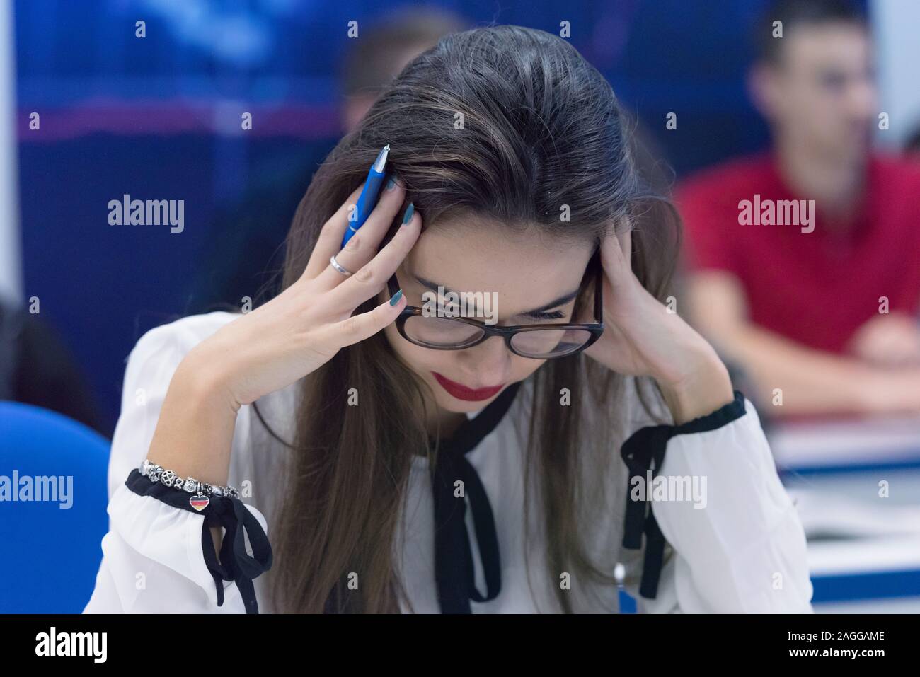 Young female student in math class overwhelmed by the math formula ...
