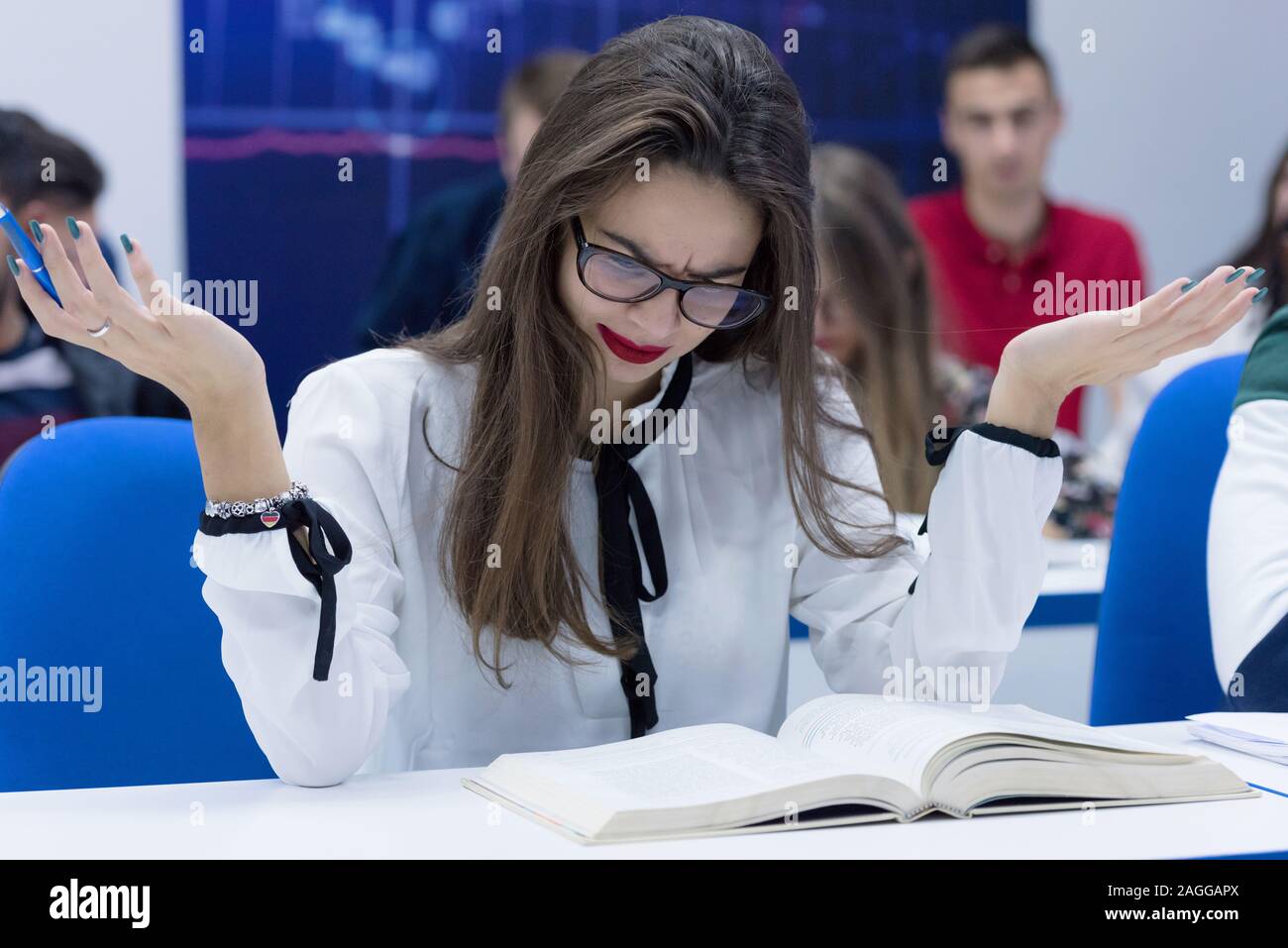 Young female student in math class overwhelmed by the math formula ...