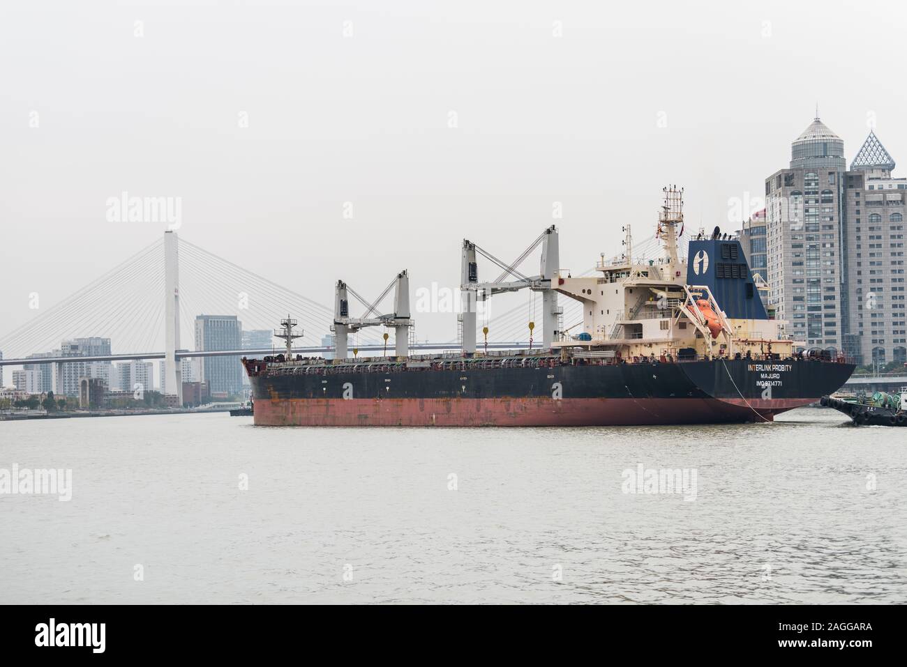 Cargo ship sailing on the Huangpu River, the bund of Shanghai, view ...