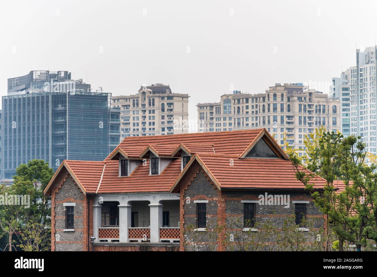 A red tile traditional house and modern skylines in Shanghai, China ...