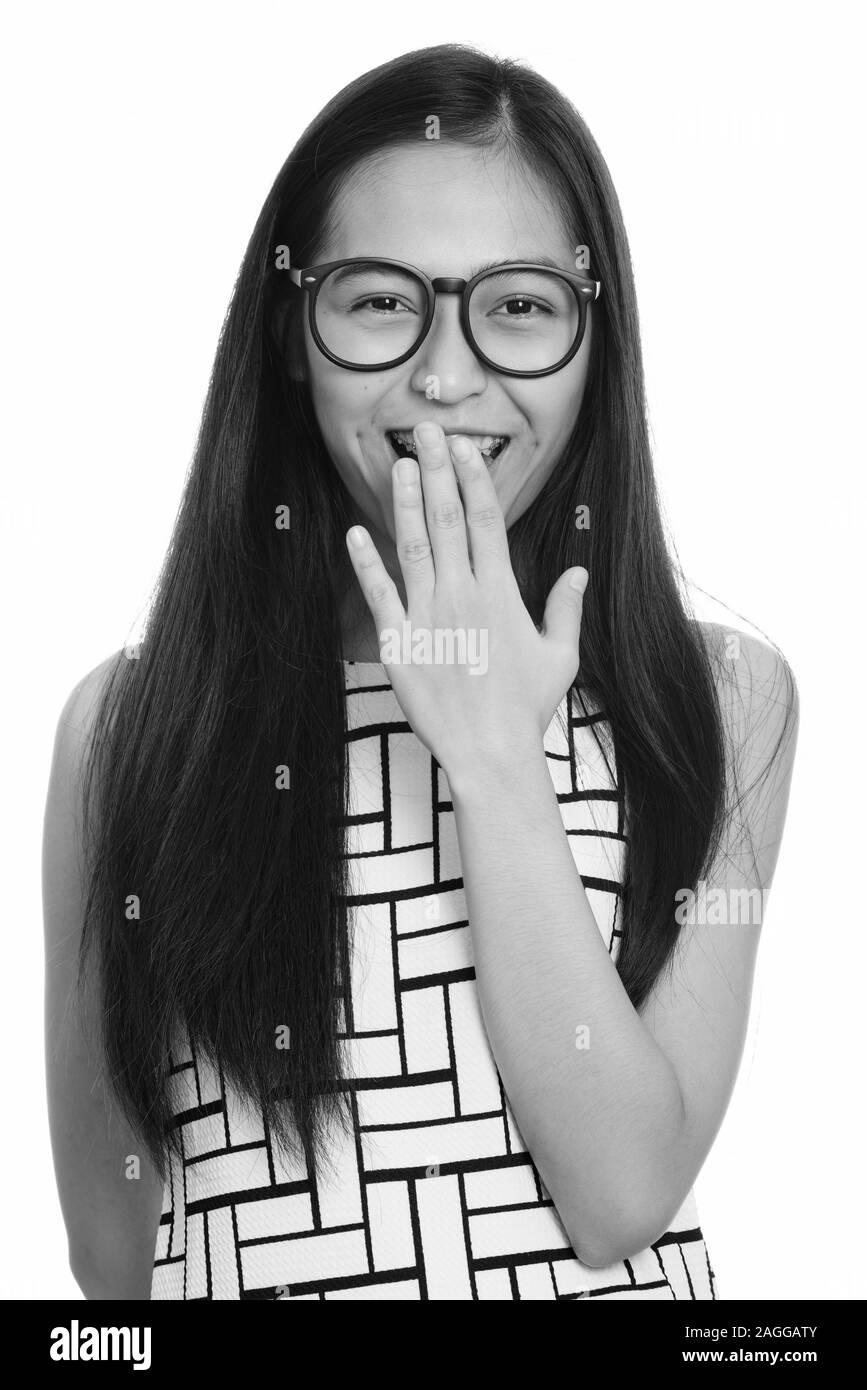 Young happy Asian teenage nerd girl smiling and laughing while covering mouth Stock Photo - Alamy