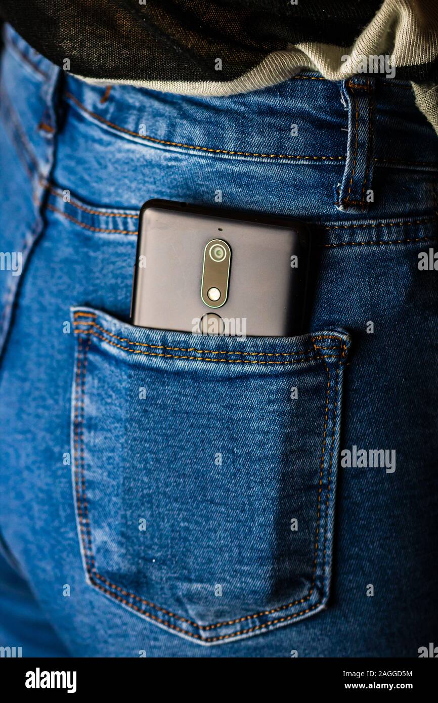 Close up smartphone in jeans back pocket. Business and fashion concept ...