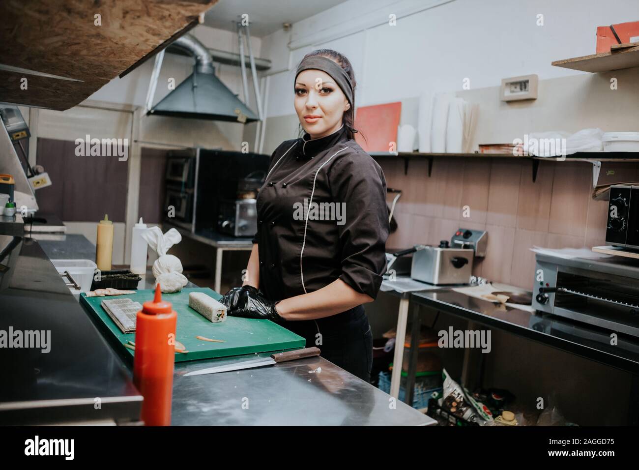 beautiful woman chef prepares sushi on restaurant kitchen Stock Photo ...