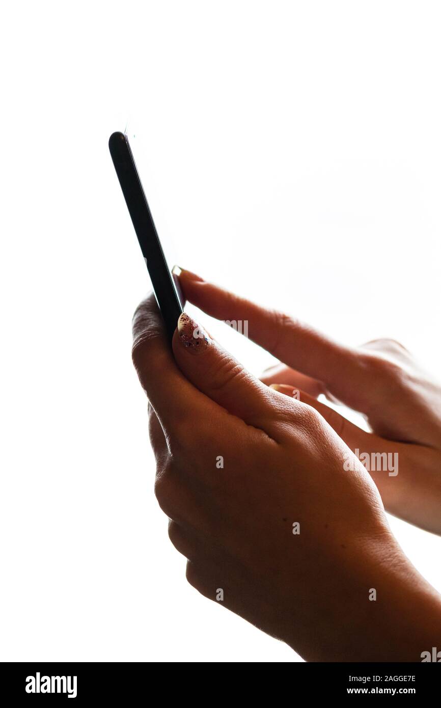 Woman hand holding a black smartphone in her hand. Teenage girl using a ...