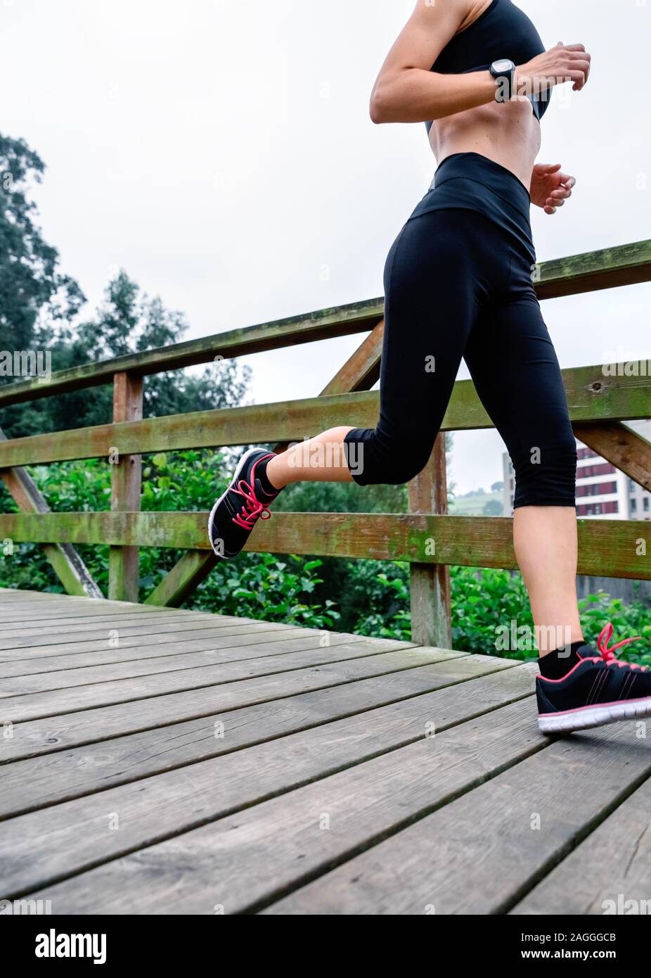 Woman running through an urban park Stock Photo - Alamy