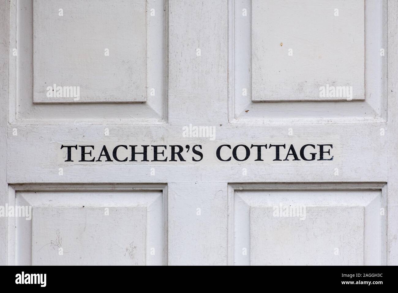 White door with the words Teacher's Cottage Stock Photo - Alamy