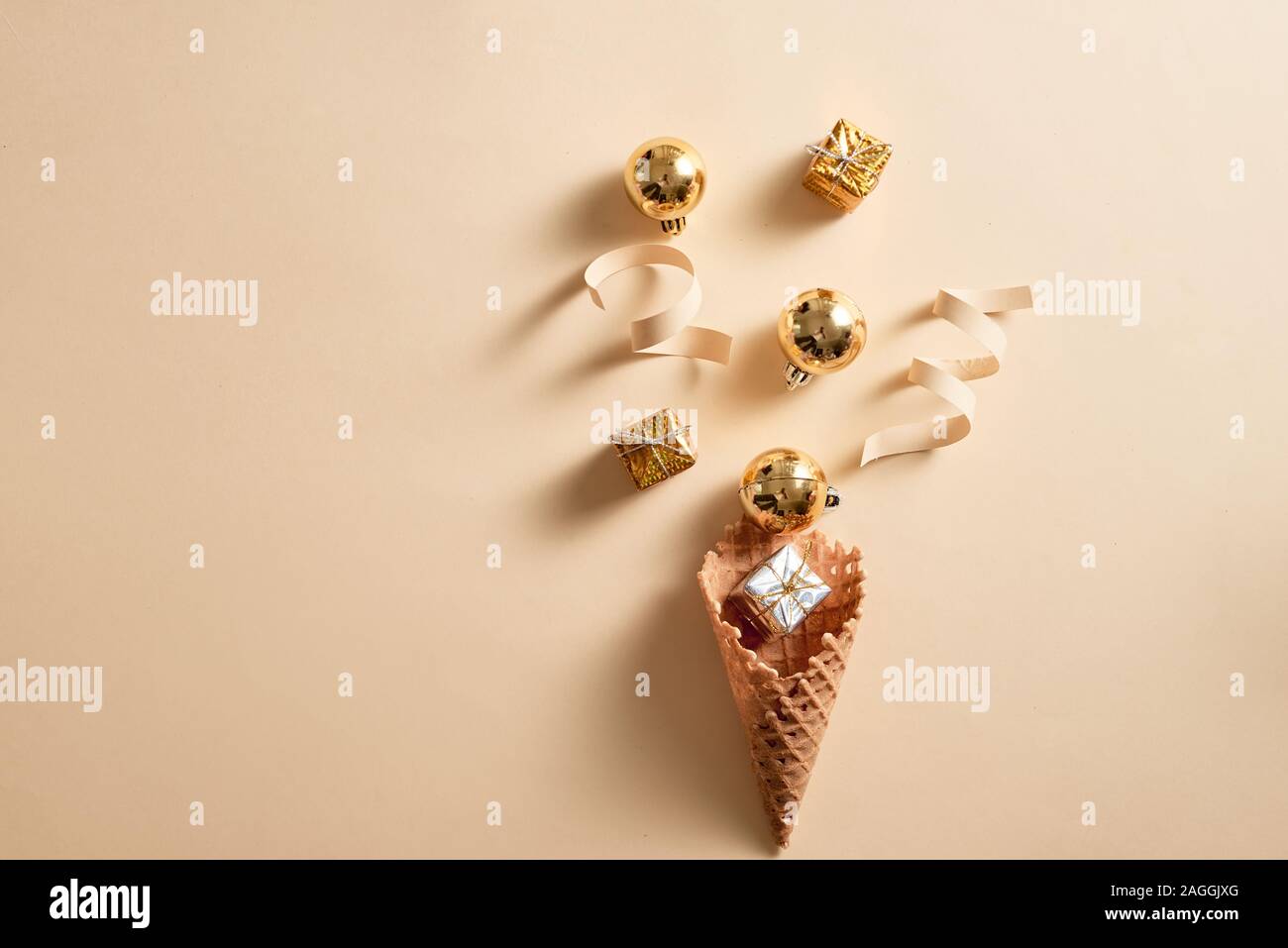 Ice cream waffle cone with ribbon and balls ornament topping. Skin ...