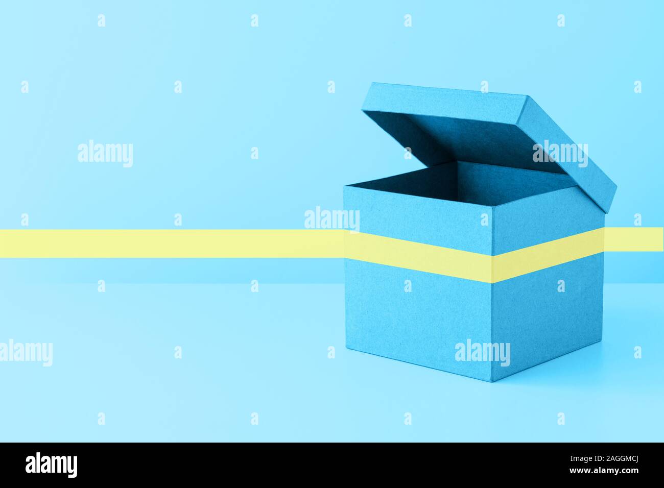 Half-open cardboard box, gift box. Blue color with yellow band. Place ...