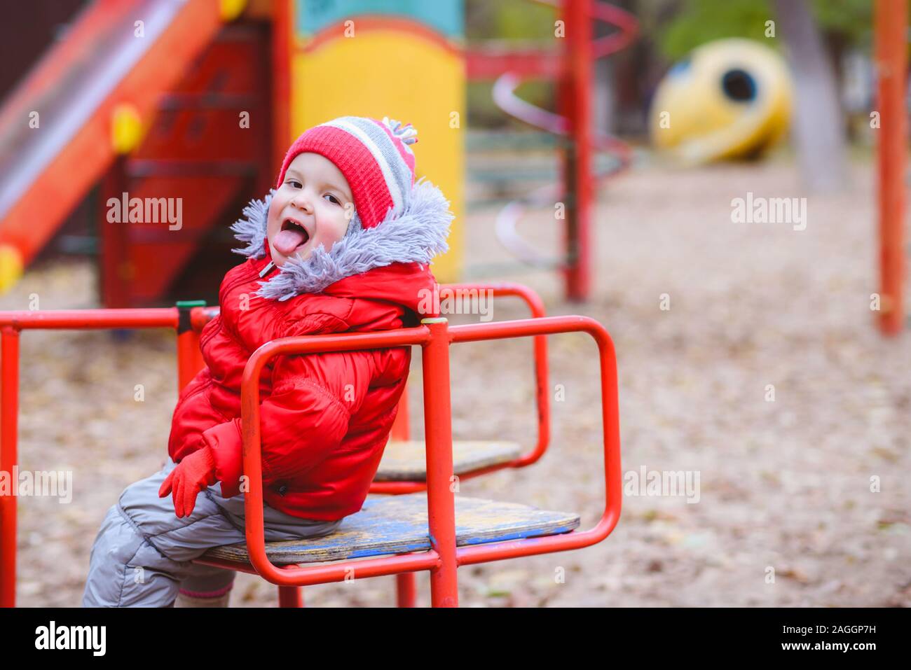 the kid is spinning on a swing in the playground in the park Stock ...