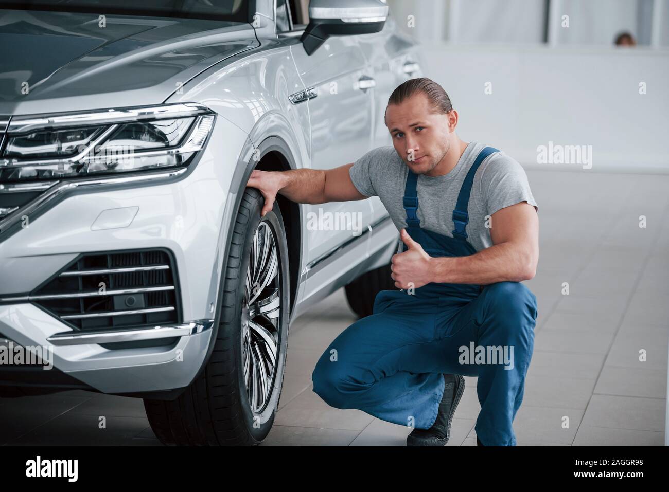 Touching the wheel. After professional repairing. Man looking at ...