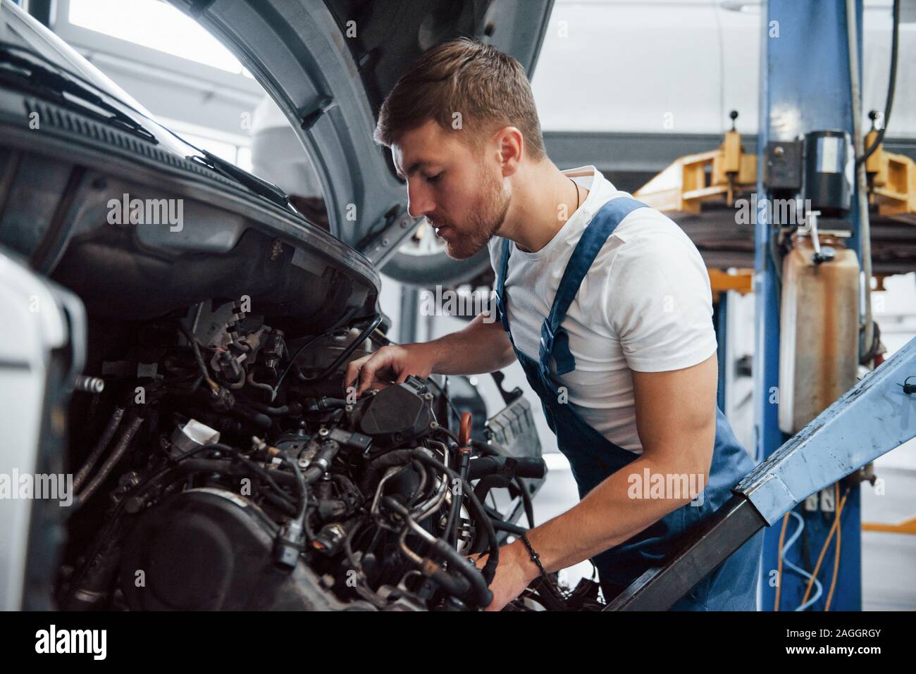 Inside of the car. Employee in the blue colored uniform works in the ...