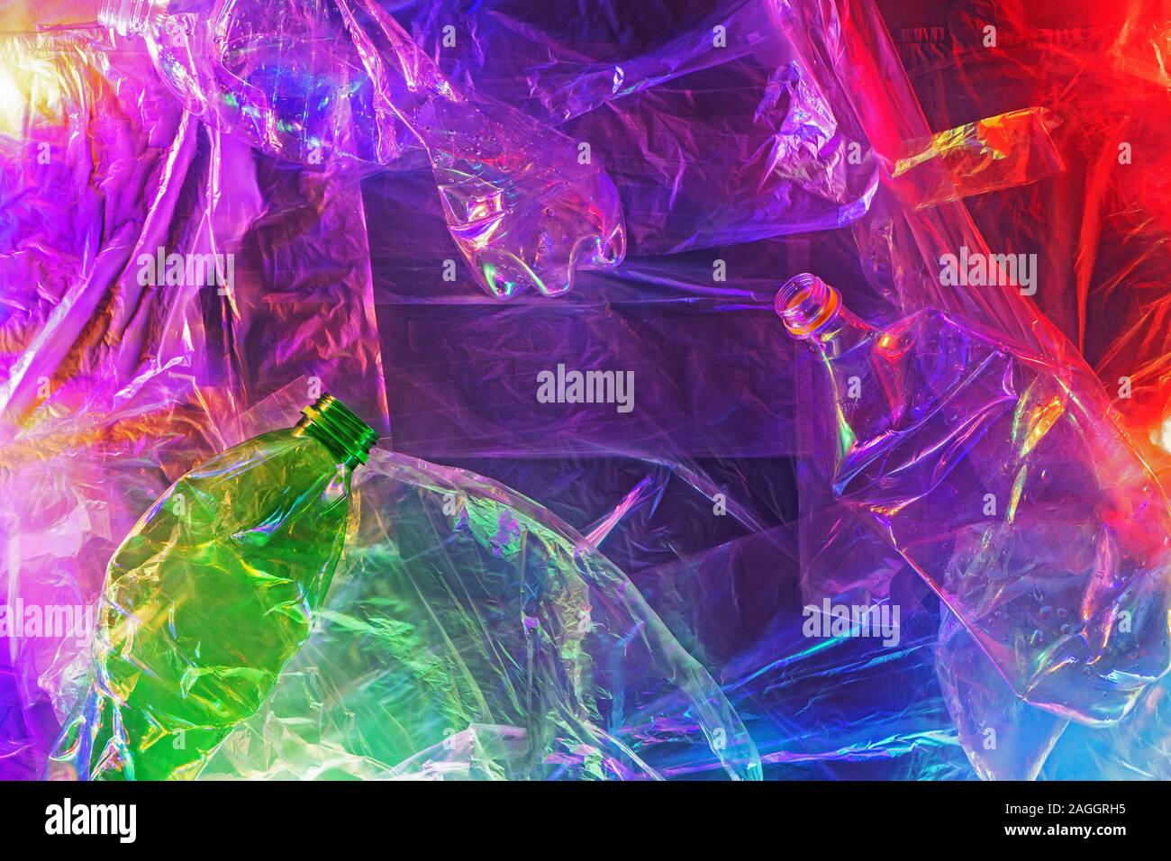 Plastic bottles on plastic background in neon lights. Zero waste ...