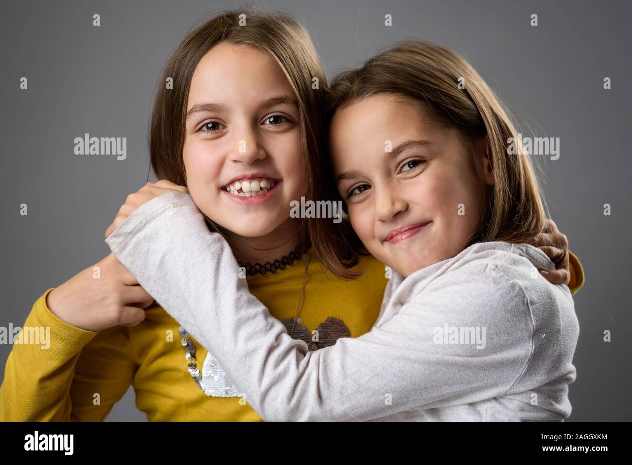 Portrait two happy sisters hugging hi-res stock photography and images ...